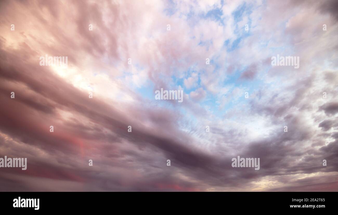 Colorful and dramatic sunset with red tinted clouds. Sky Background or ...