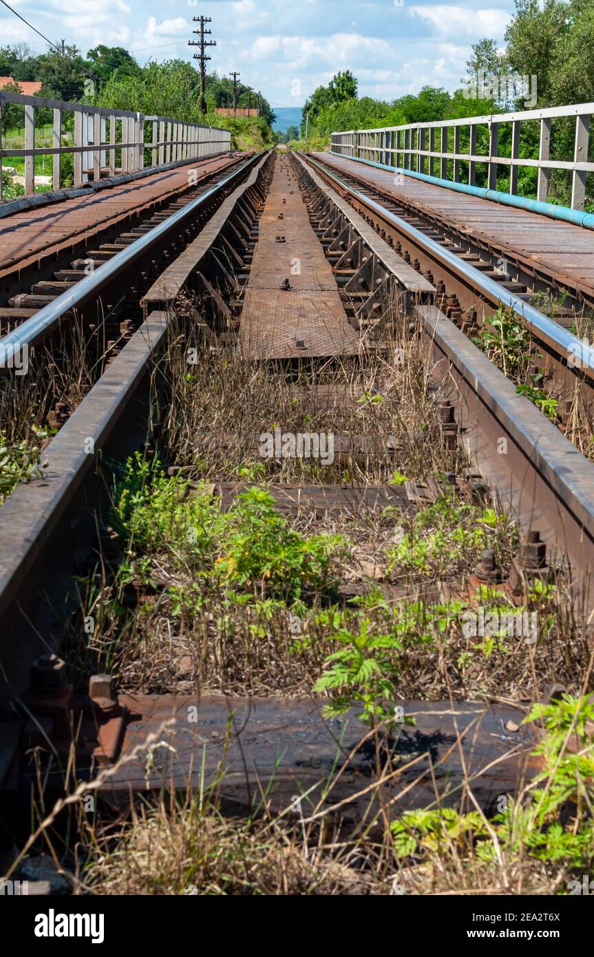 A view of an old railroad crossing a bridge. Low angle Stock Photo - Alamy