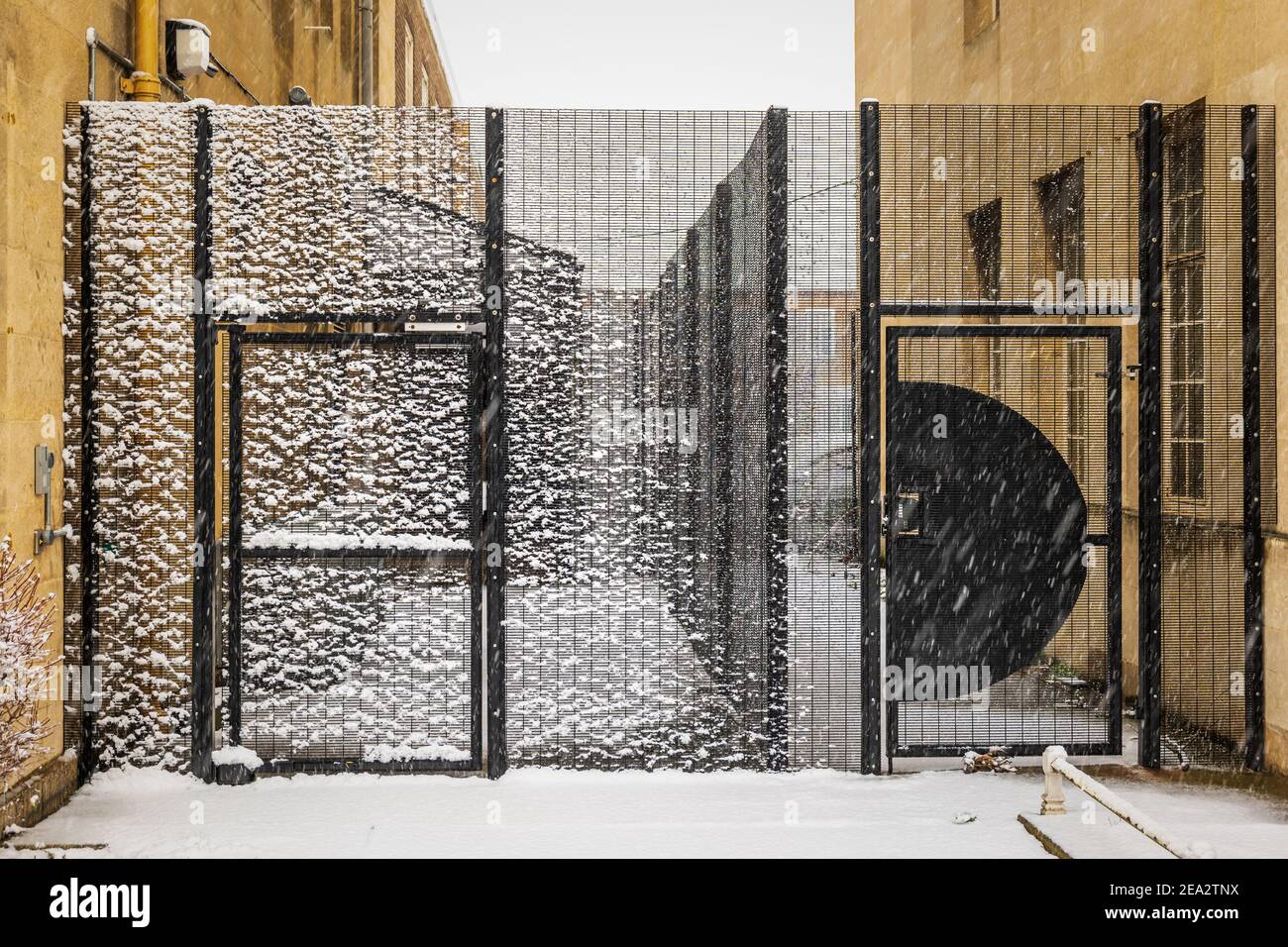 Secure metal gates shut close under winter snow during covid lockdown ...