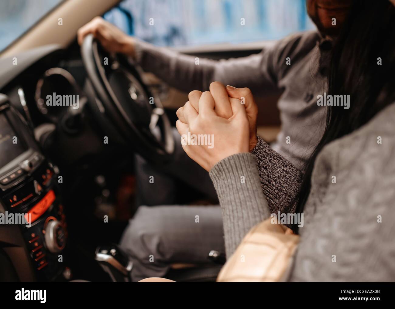 couple holding hands in car in cold season Stock Photo - Alamy