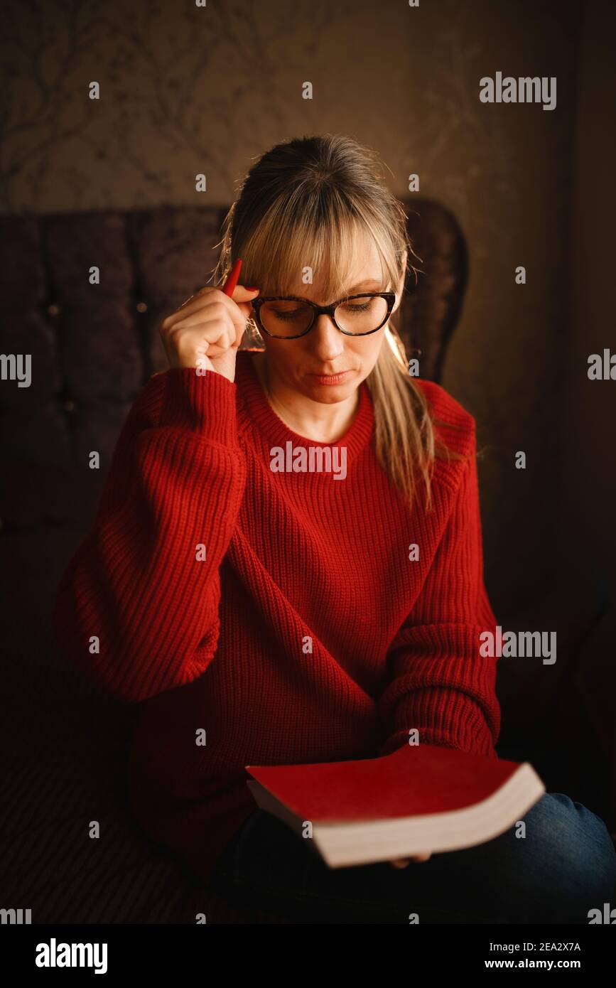Woman in red sweater glasses hi-res stock photography and images - Alamy