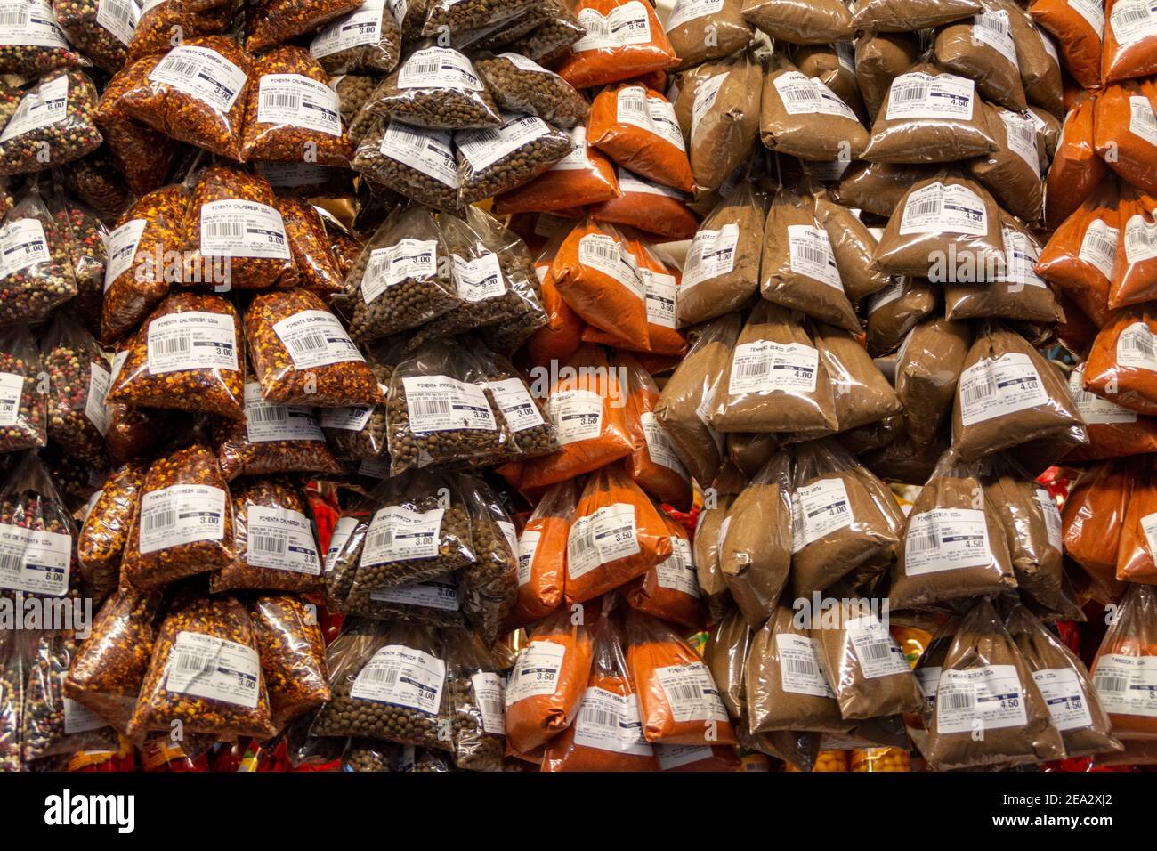 Rows of small packets of spices on sale at a large spice store at the ...
