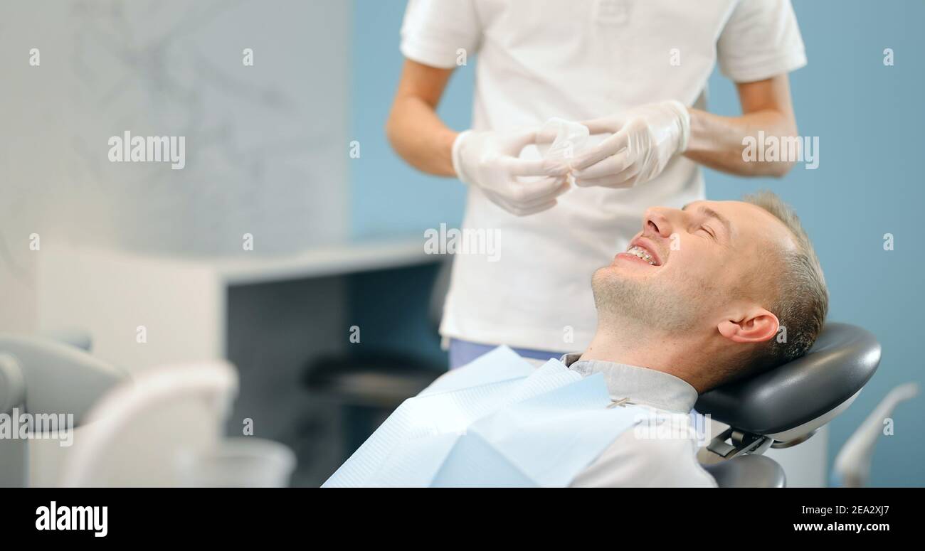 Dentist wearing optragate for the male patient Stock Photo - Alamy