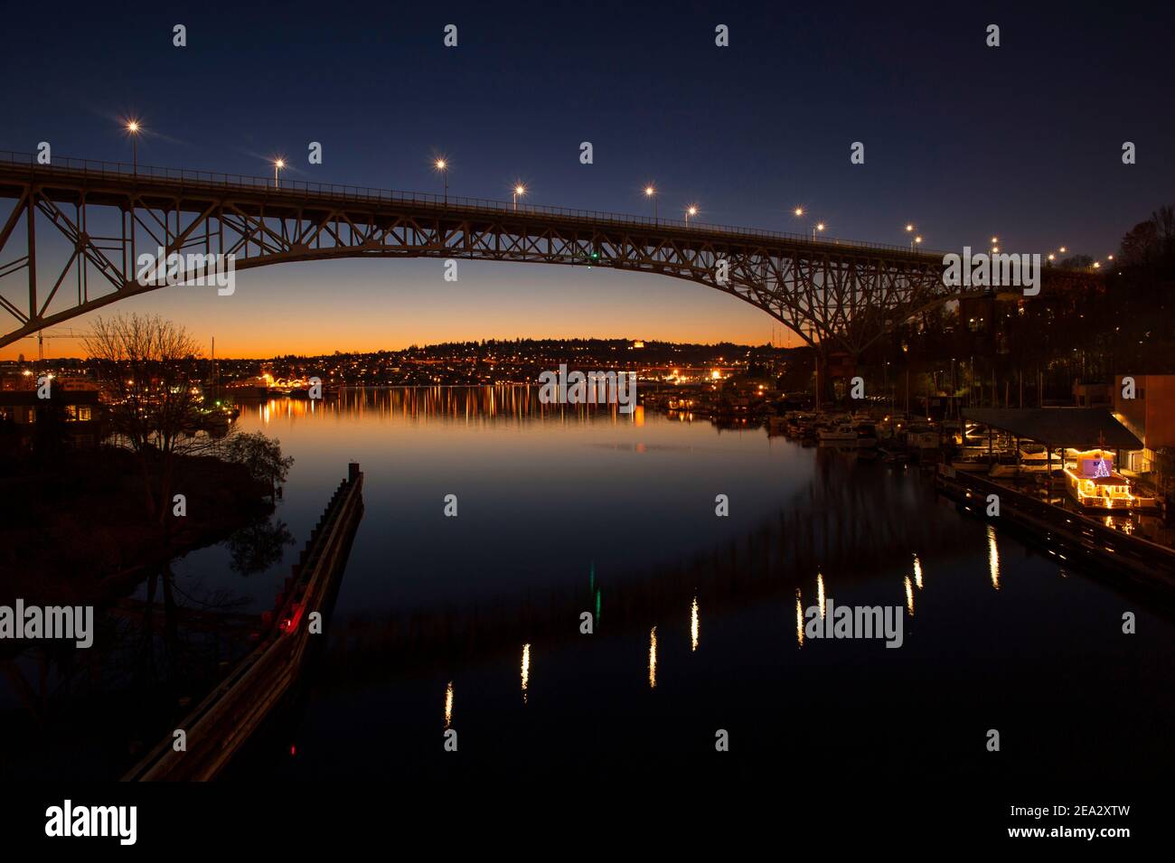 Aurora Bridge silhouetted at sunrise over Lake Union with city lights ...