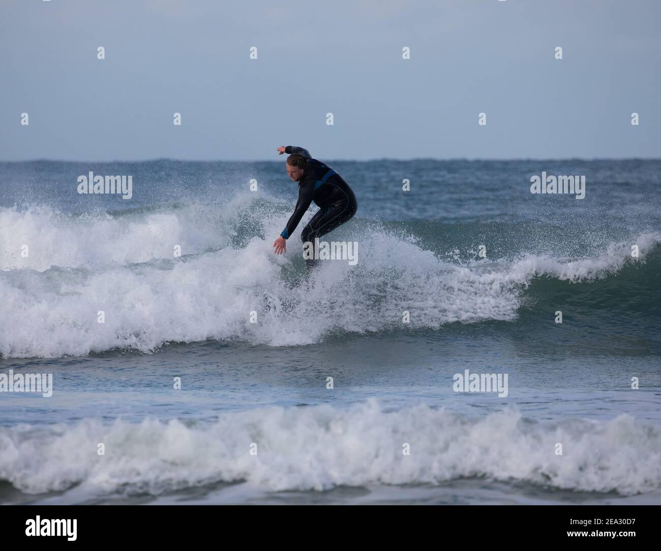 Surfers seen from St Gothian Sands in Cornwall, UK Stock Photo - Alamy