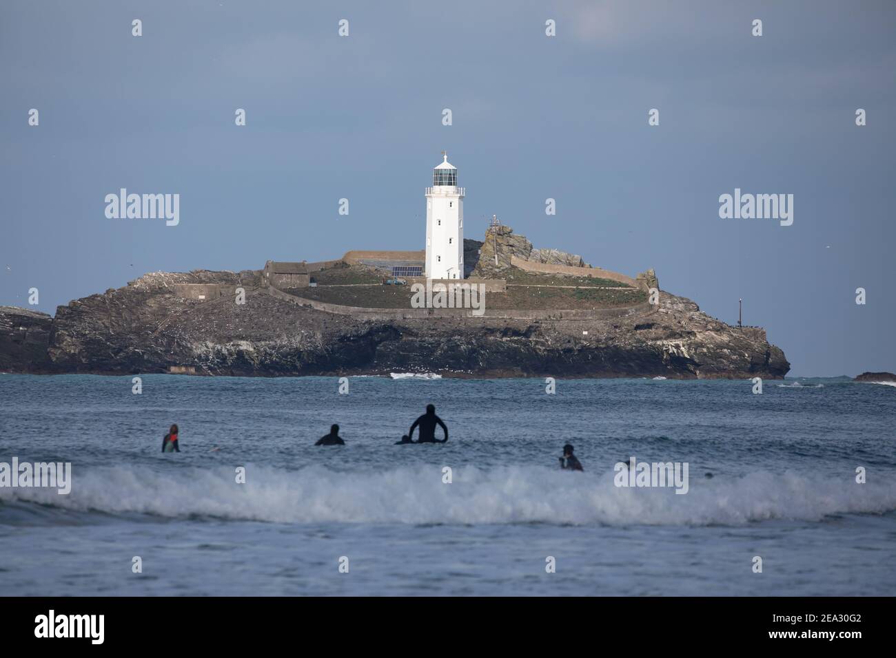 Surfers seen from St Gothian Sands in Cornwall, UK Stock Photo - Alamy