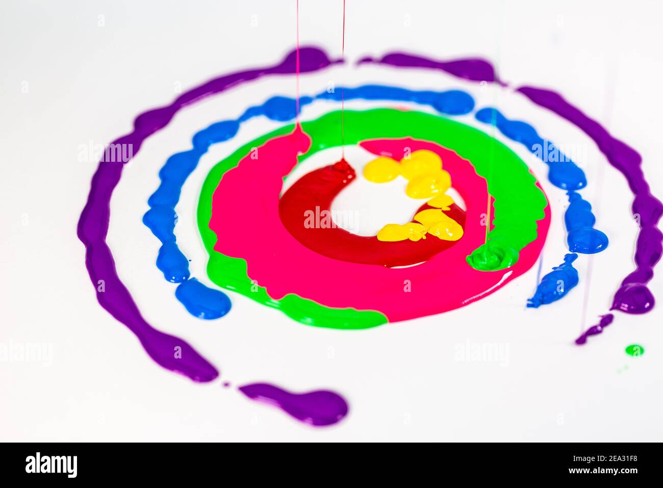 Various colors drop in lines on a white circle radial background and ...