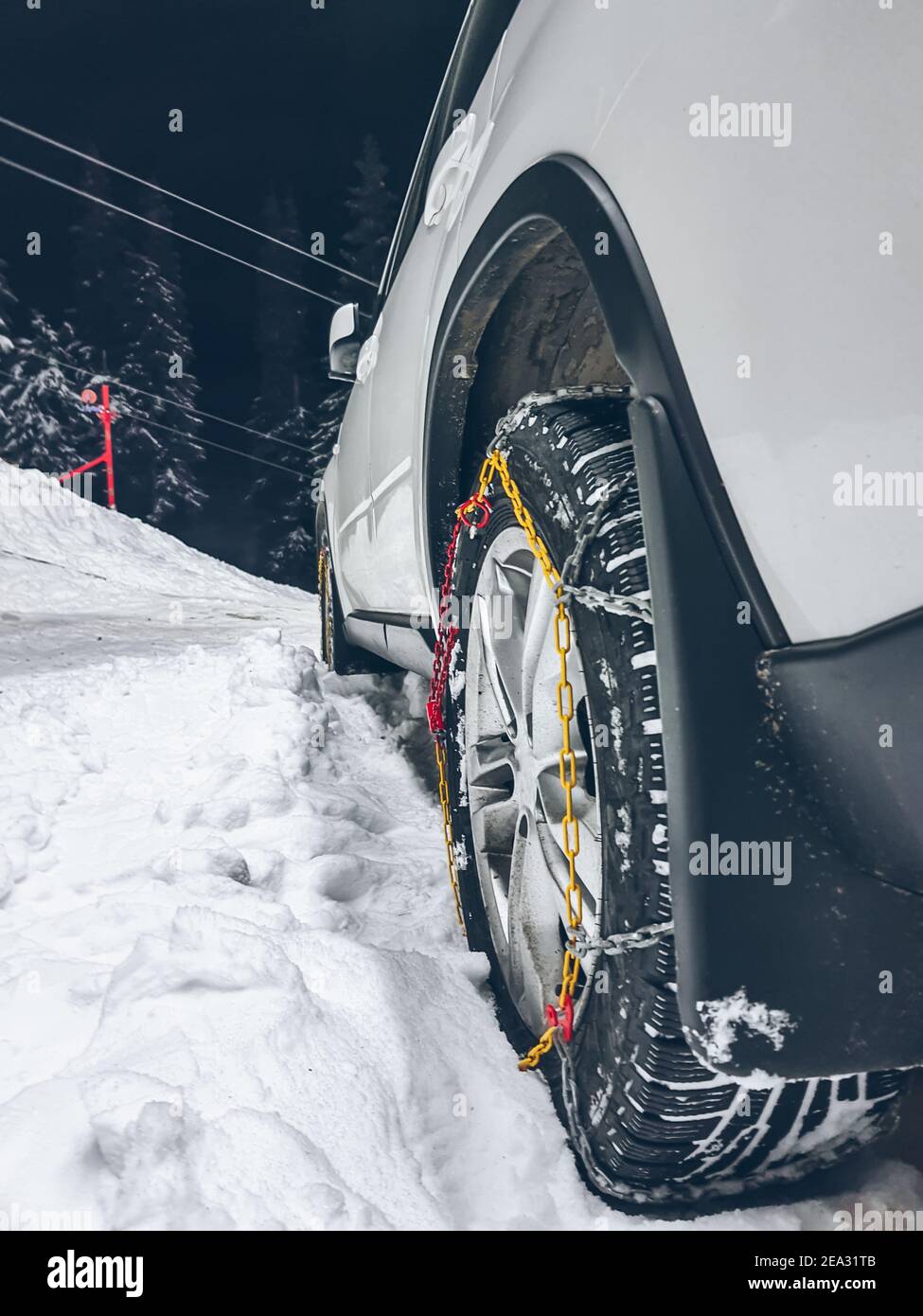 car wheels in chains close up snowed road copy space Stock Photo - Alamy