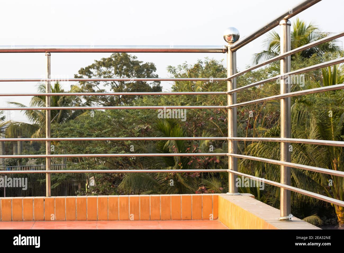 Metal railing on the rooftop of a house with nature view Stock Photo ...
