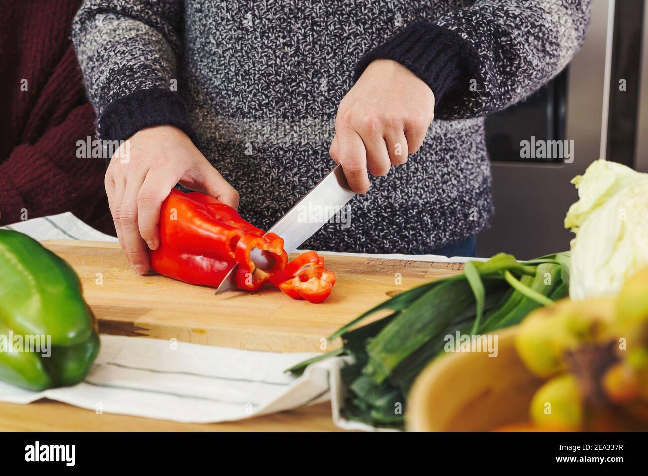 Stock photo of a close up shot of a man's hands cutting vegetables in ...