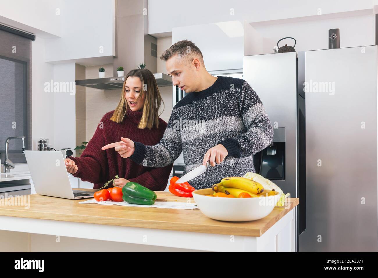 Stock photo of a young couple enjoying and preparing healthy meal in ...