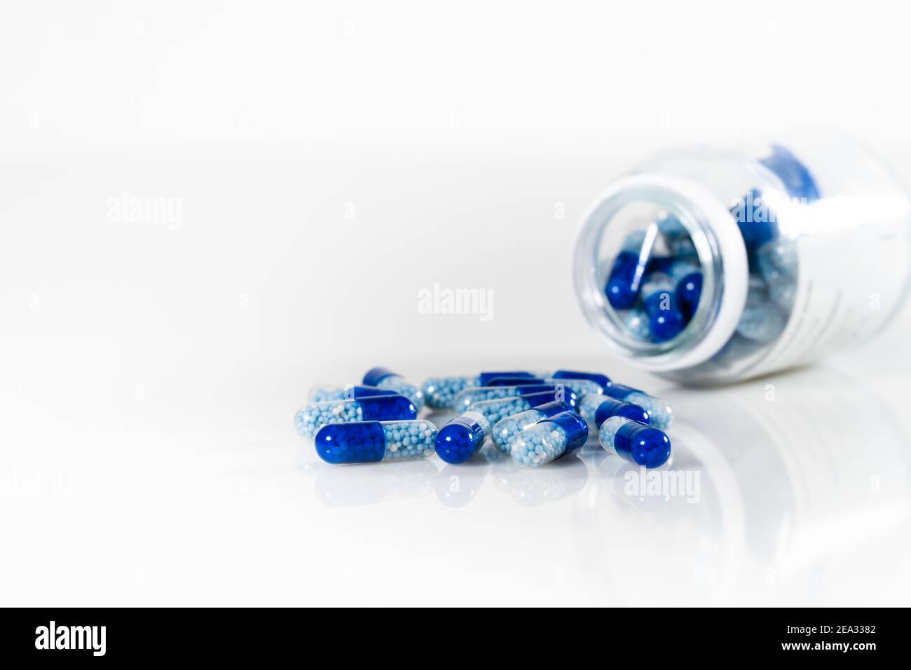 Close-up of blue medical capsules isolated on the white background ...