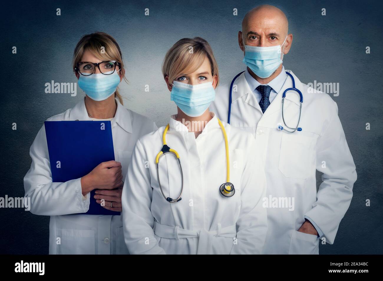 Shot of female and male doctors standing together at isolated ...