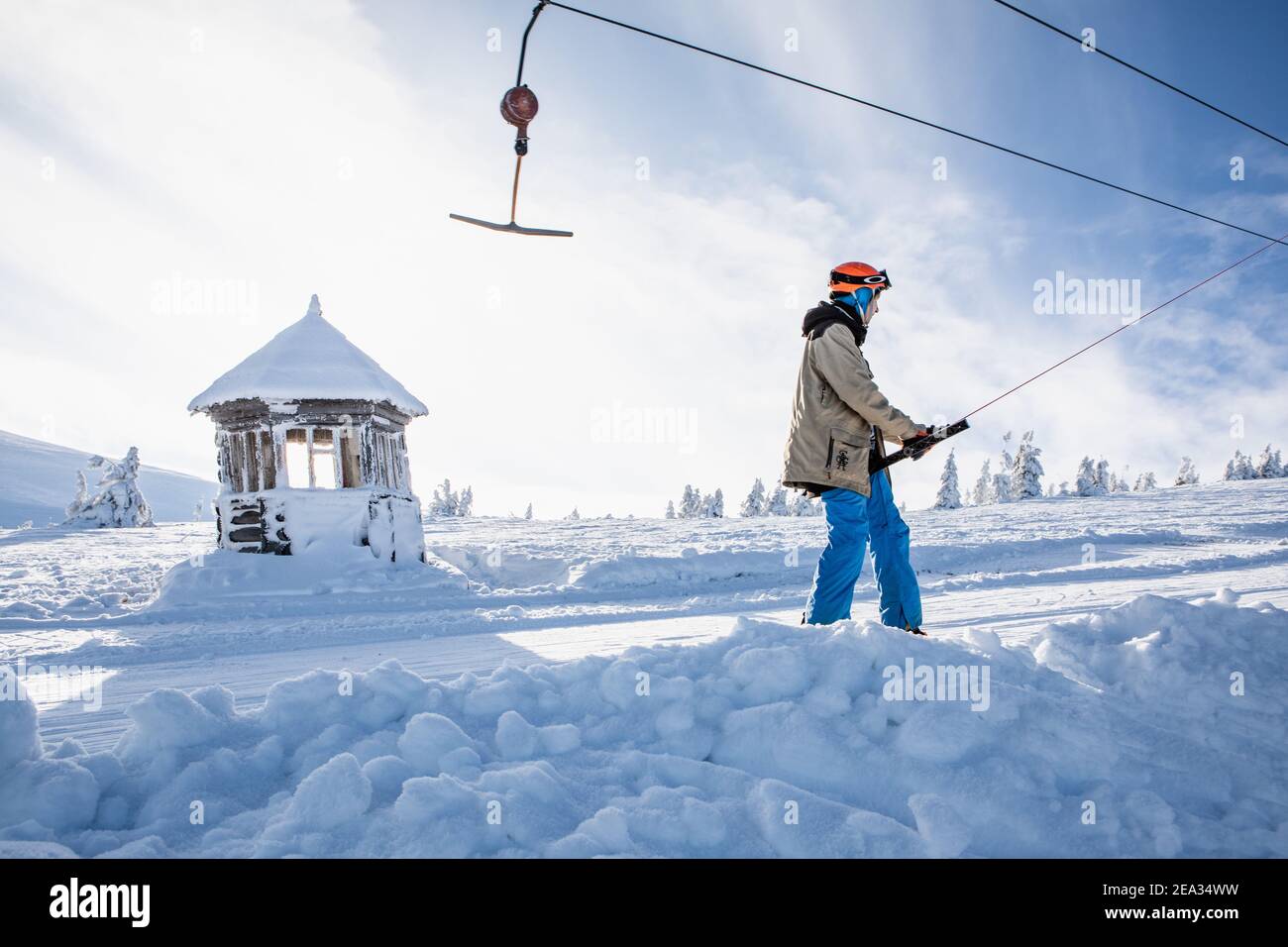 Dragobrat, Ukraine -January 11, 2021: man snowboarder using ski yoke to ...