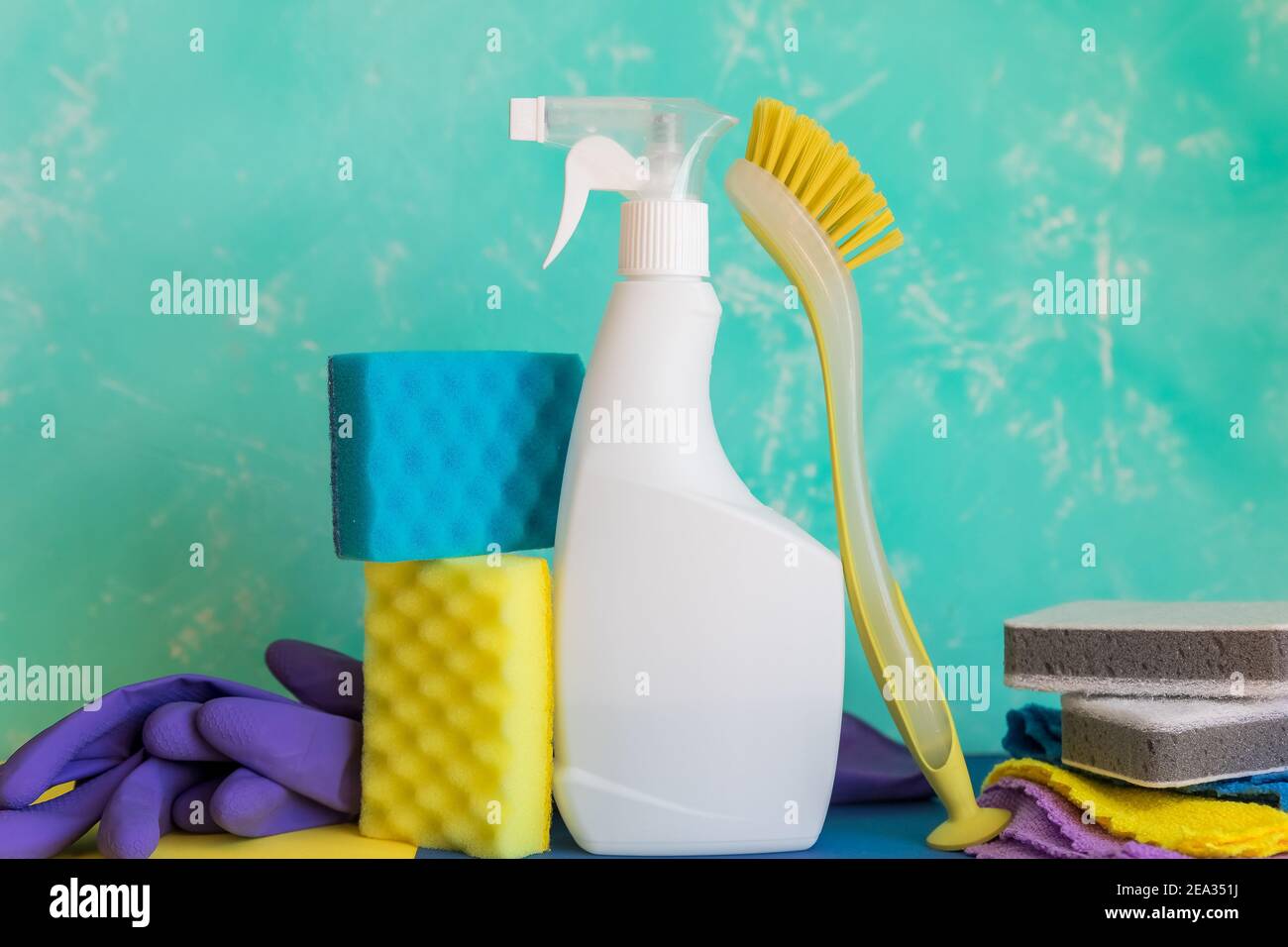 Variety of colorful house cleaning products on blue background.Clean up ...