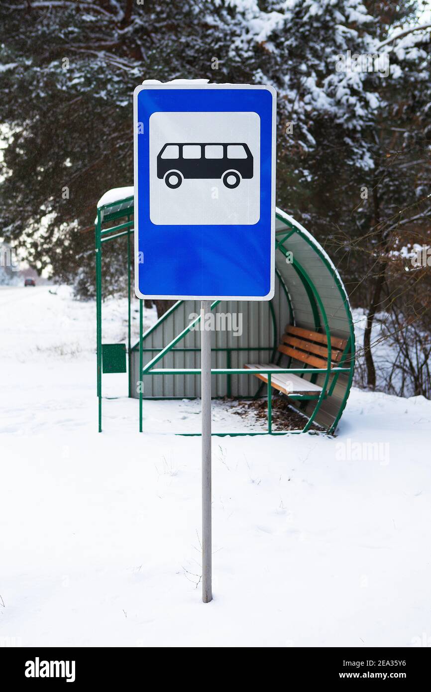 Bus stop in the middle of a beautiful winter road in the middle of the ...