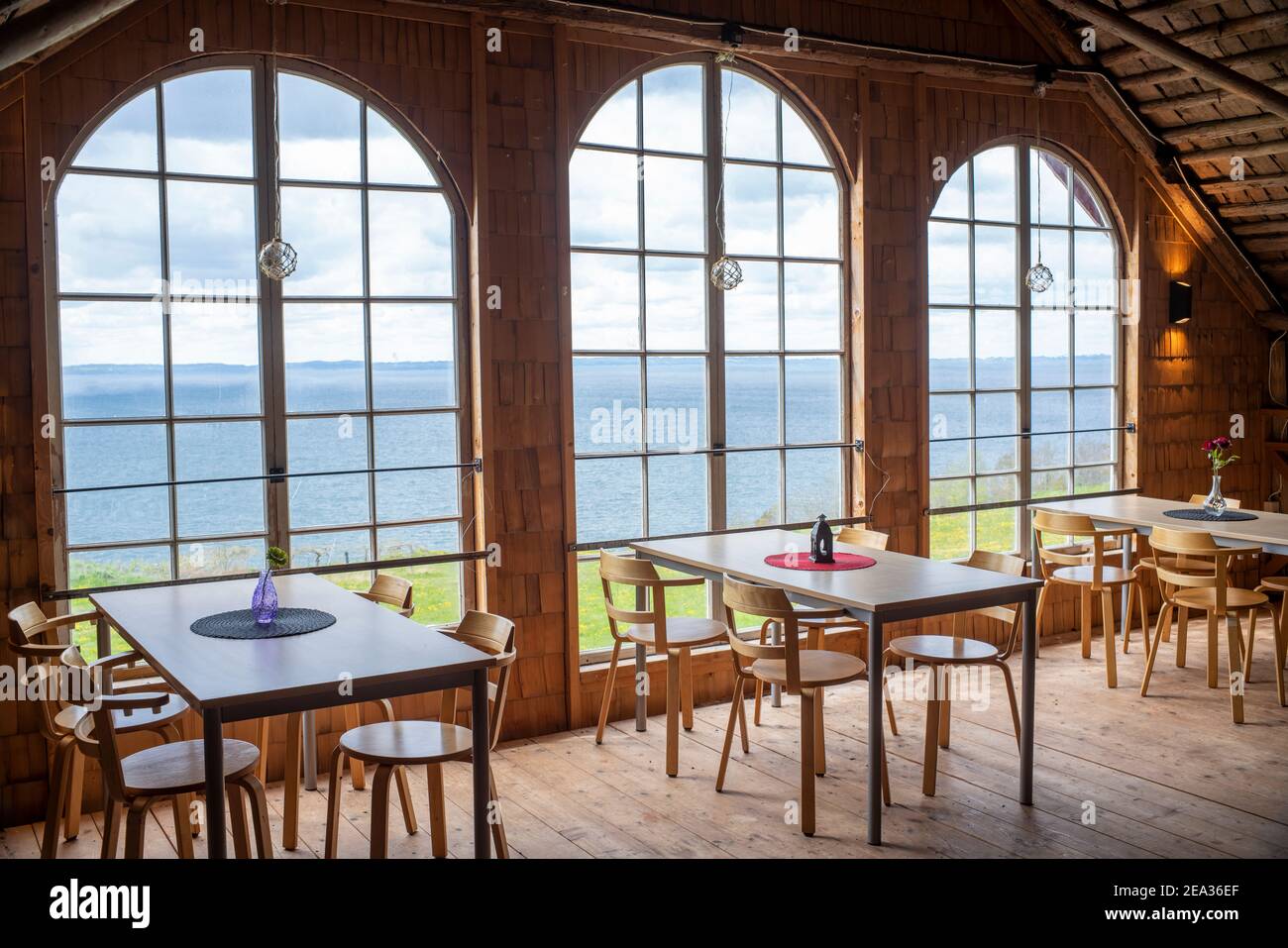 Modern Barn interior With Big Windows and Dining table Stock Photo - Alamy