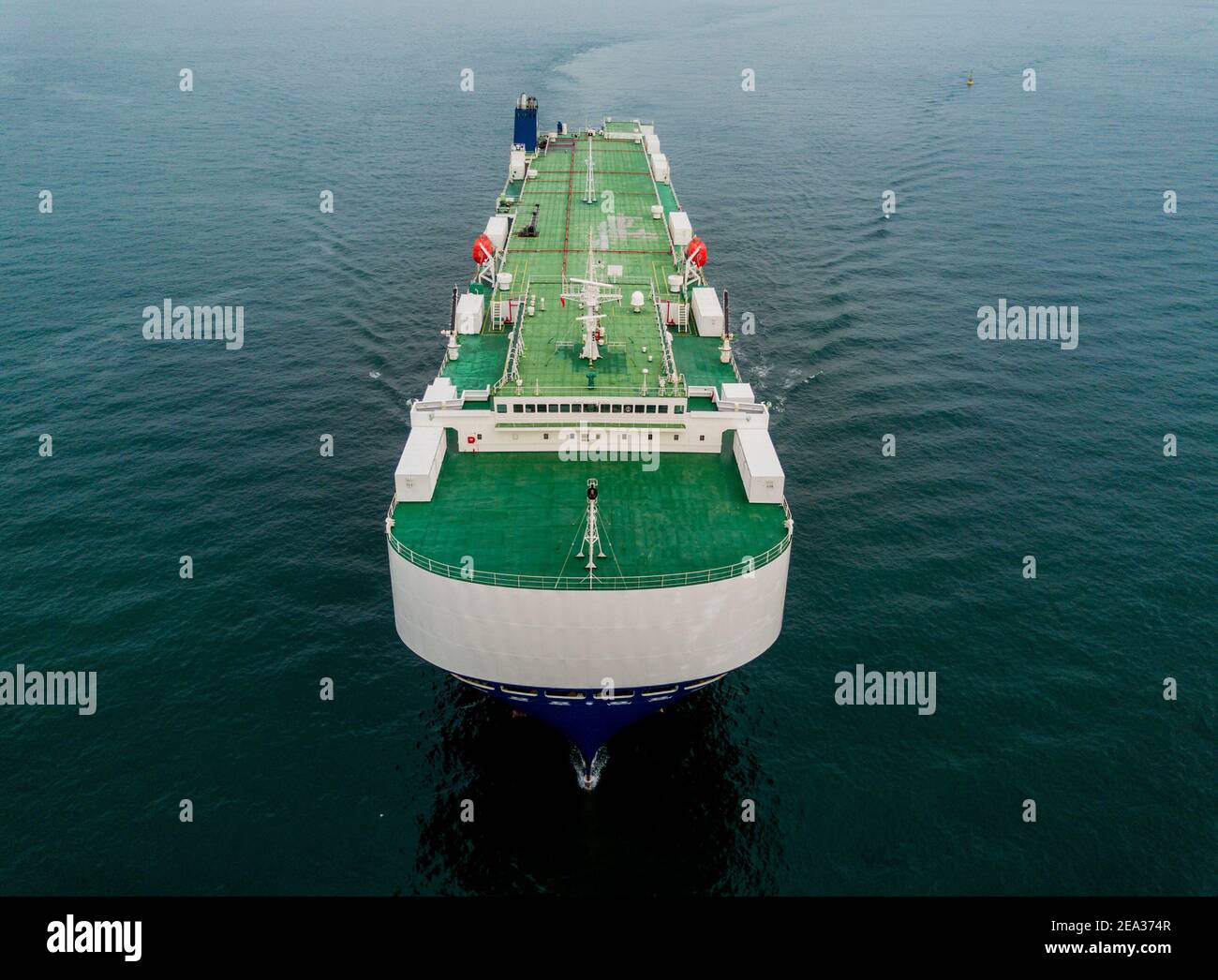 Aerial view from a drone of a container ship, carrying bulk containers ...