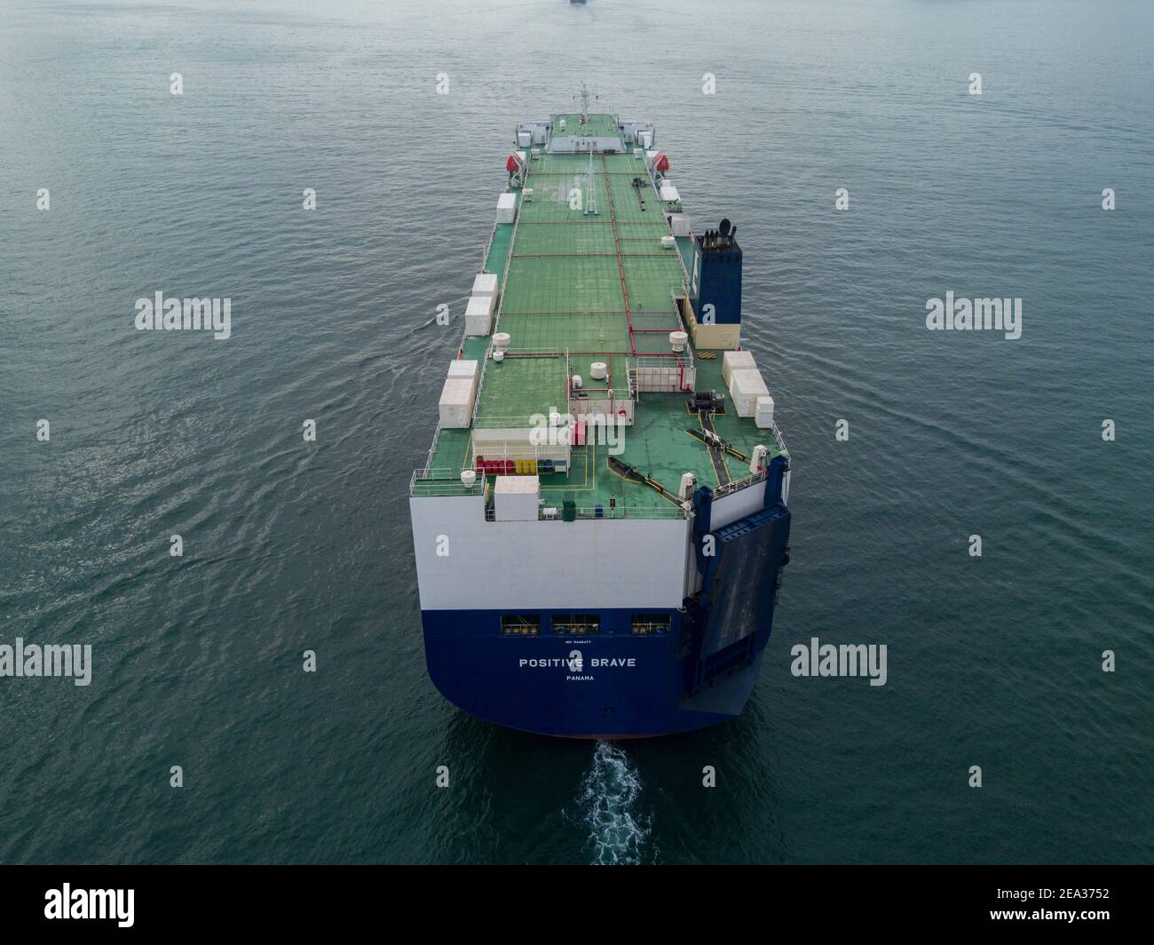 Aerial view from a drone of a container ship, carrying bulk containers ...