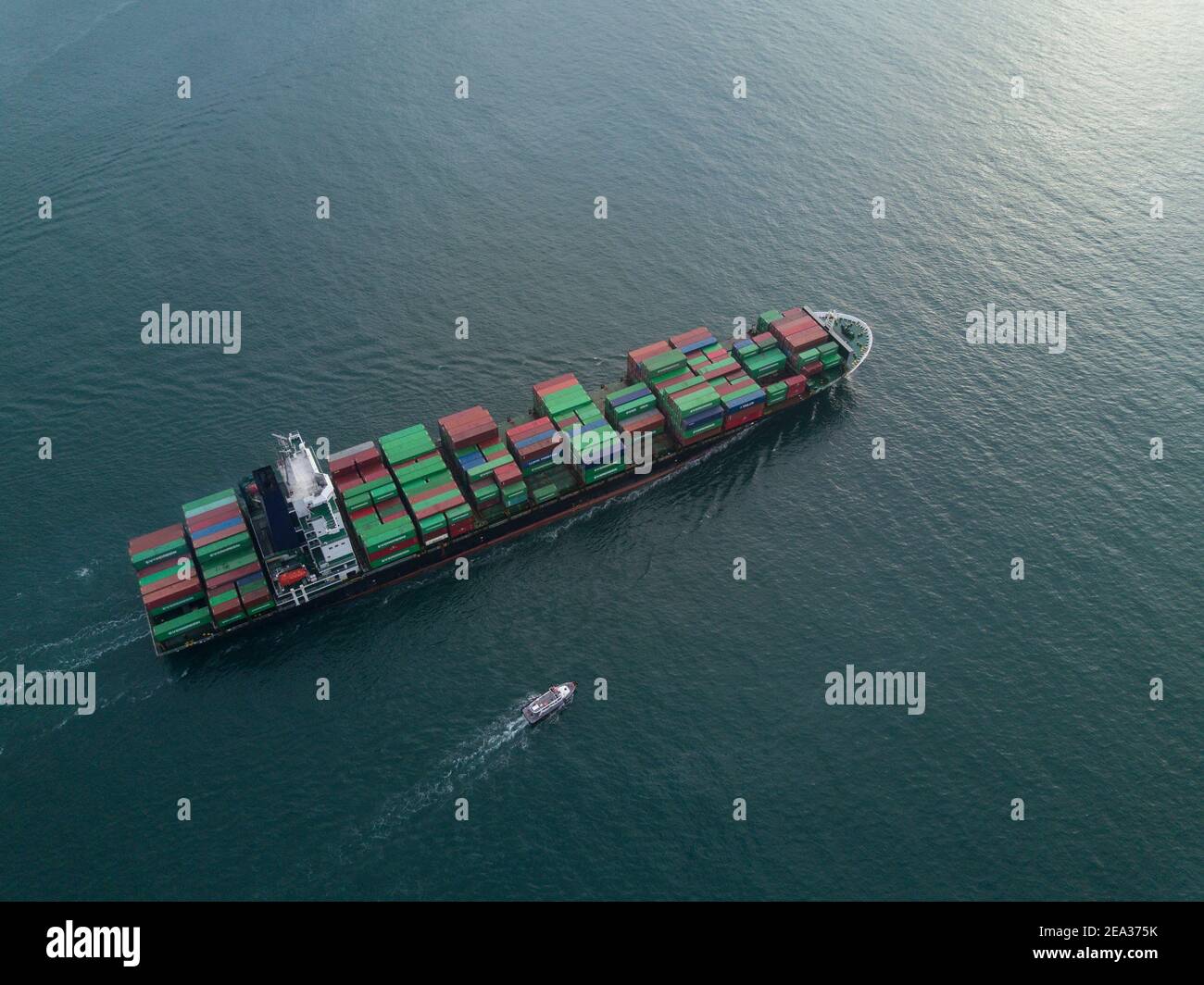 Aerial view from a drone of a container ship, carrying bulk containers ...