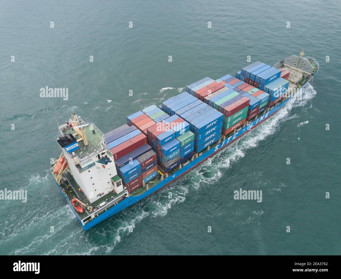 Aerial view from a drone of a container ship, carrying bulk containers ...