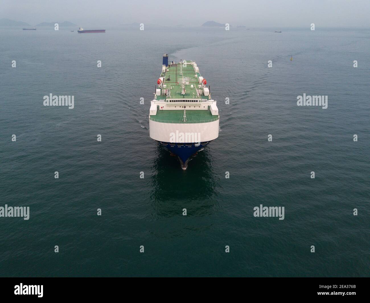 Aerial view from a drone of a container ship, carrying bulk containers ...