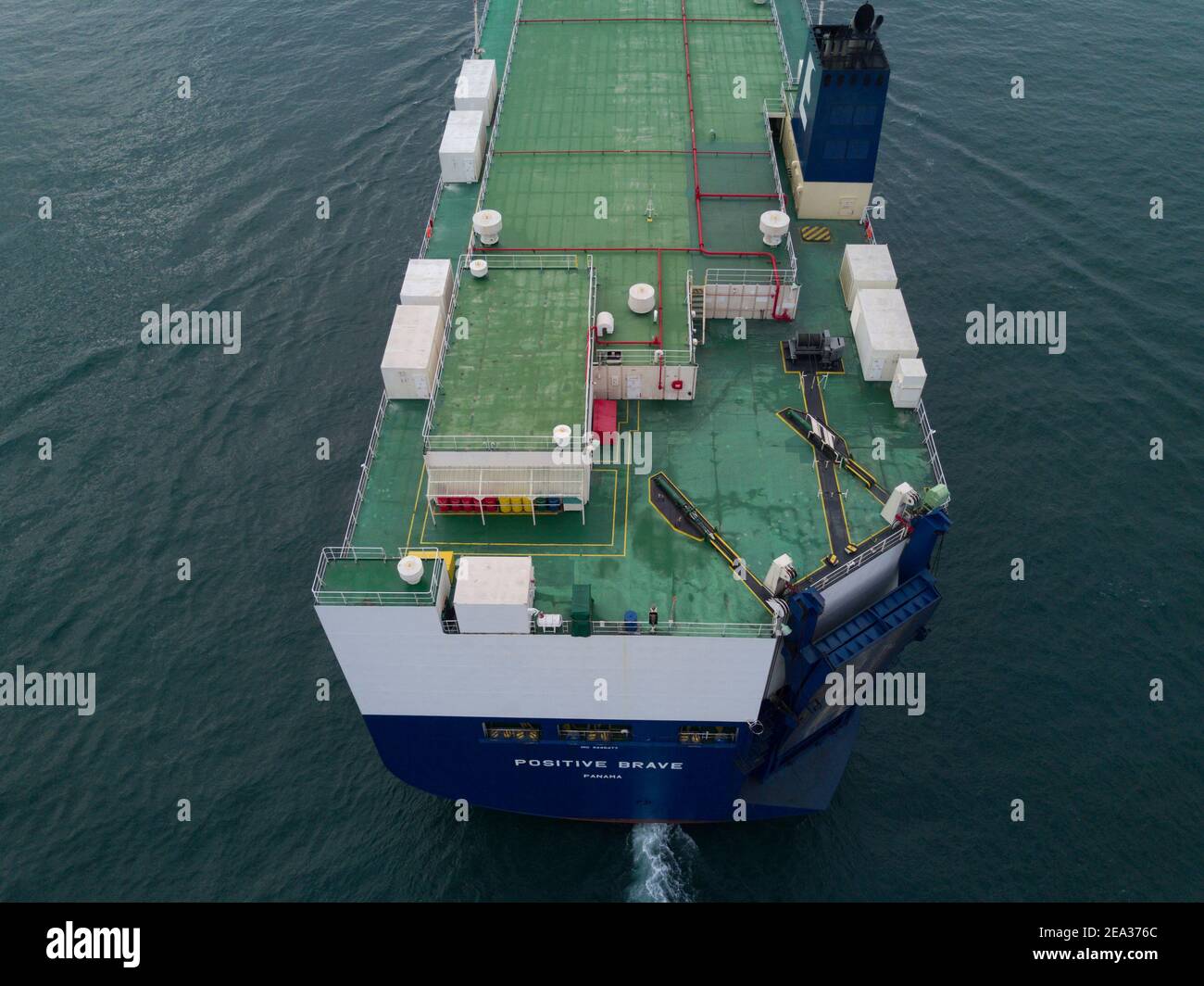 Aerial view from a drone of a container ship, carrying bulk containers ...