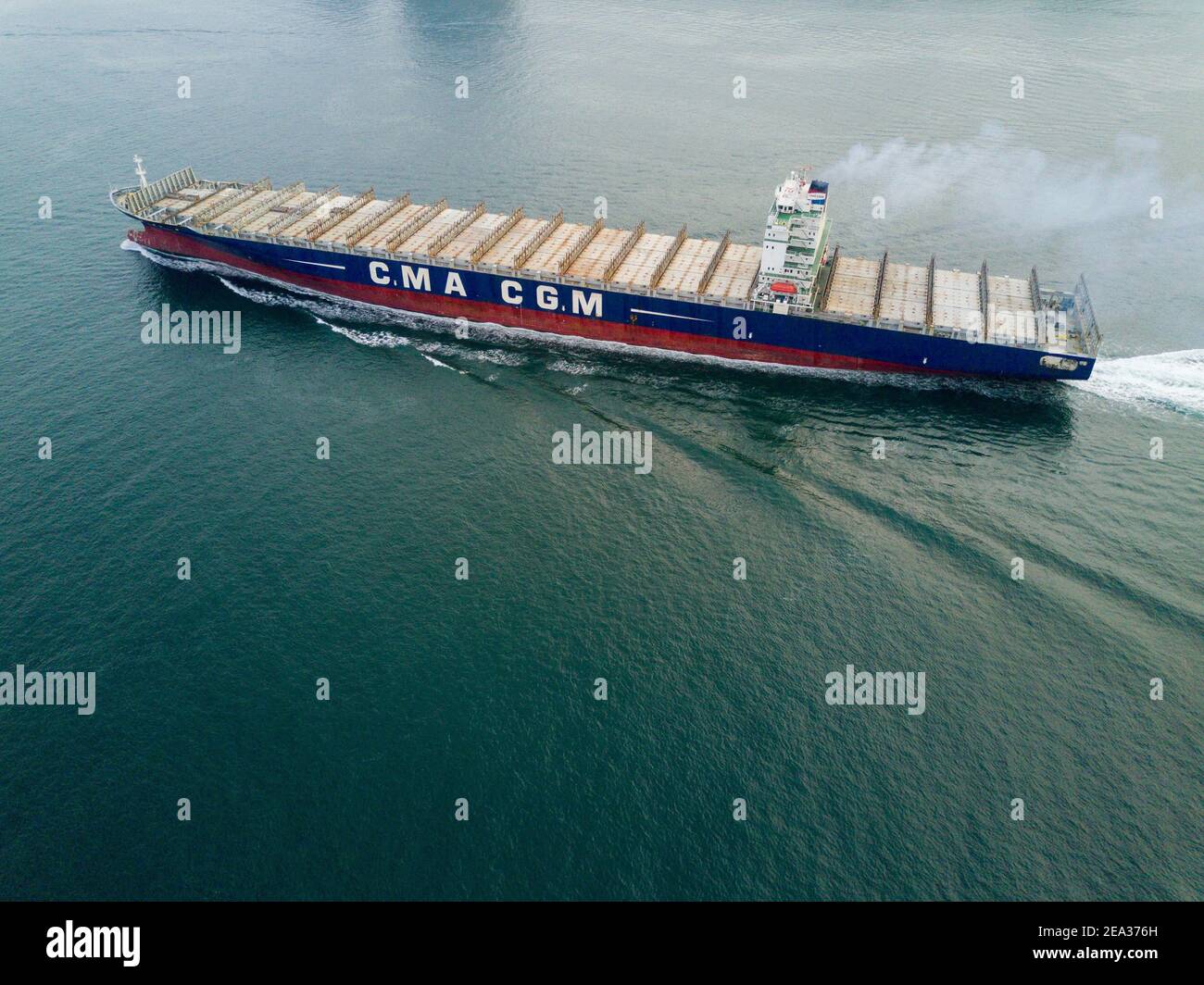 Aerial view from a drone of a container ship, carrying bulk containers ...