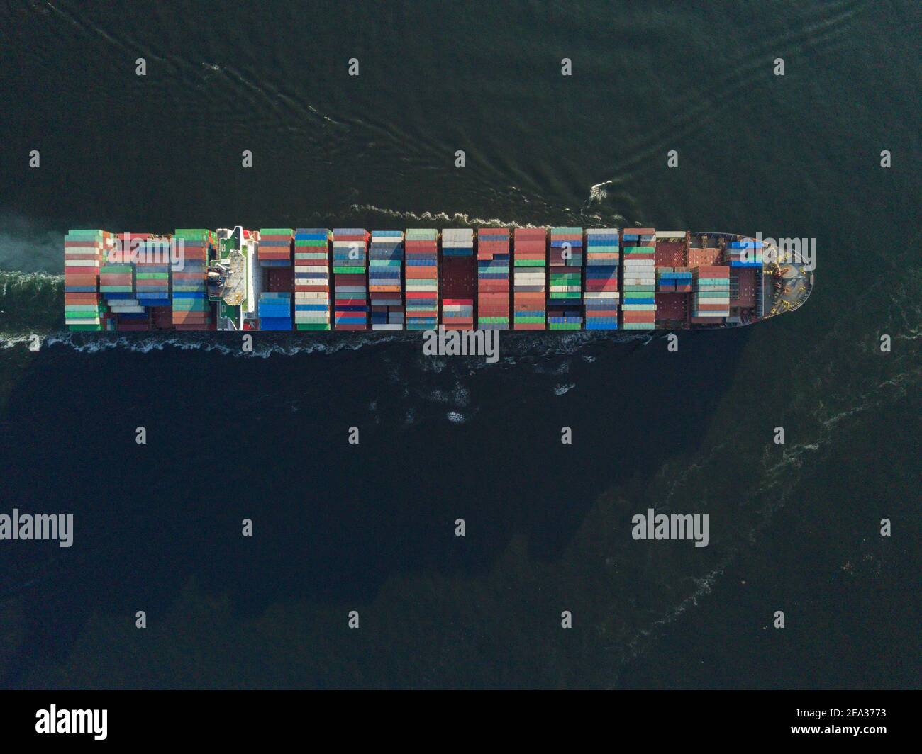 Aerial view from a drone of a container ship, carrying bulk containers ...