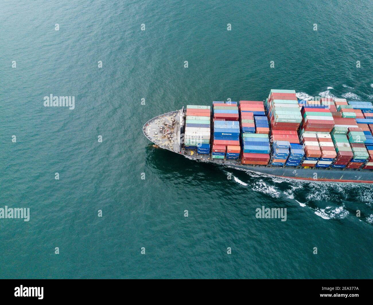 Aerial view from a drone of a container ship, carrying bulk containers ...
