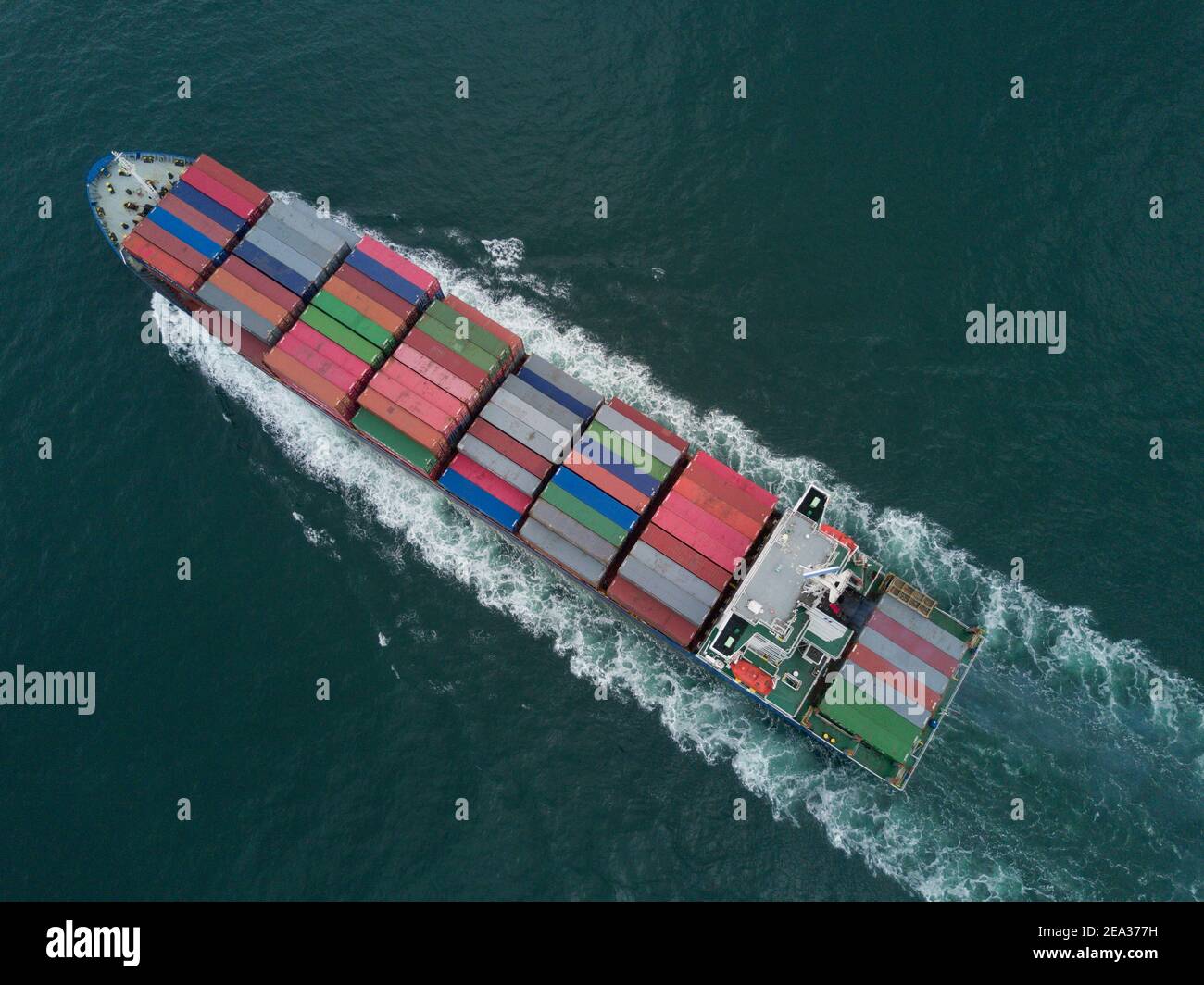 Aerial view from a drone of a container ship, carrying bulk containers ...