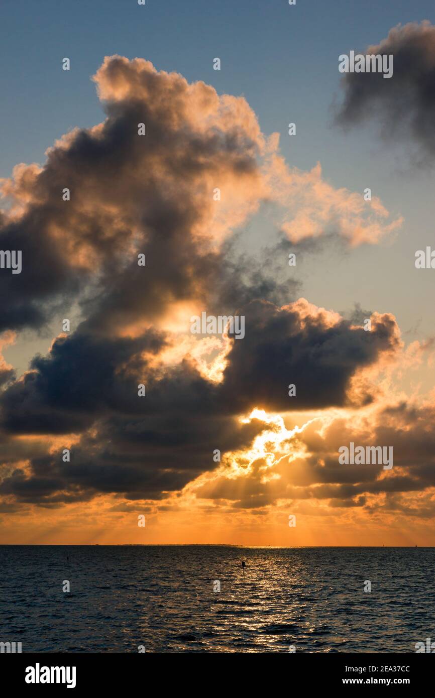 The German wadden sea at high tide during sundown. The sunlight is ...