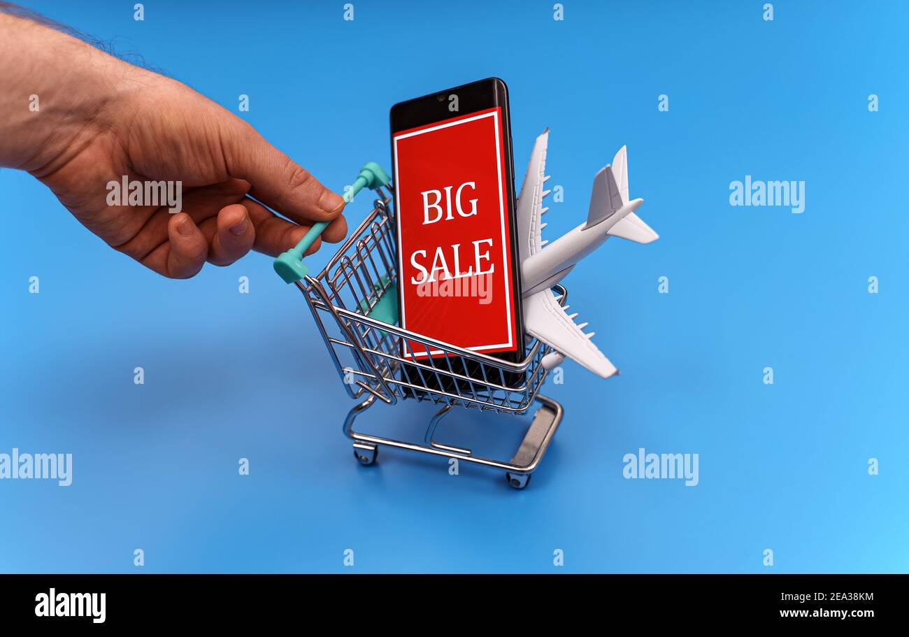 Shopping cart with plane toy. Air tickets sale concept Stock Photo - Alamy