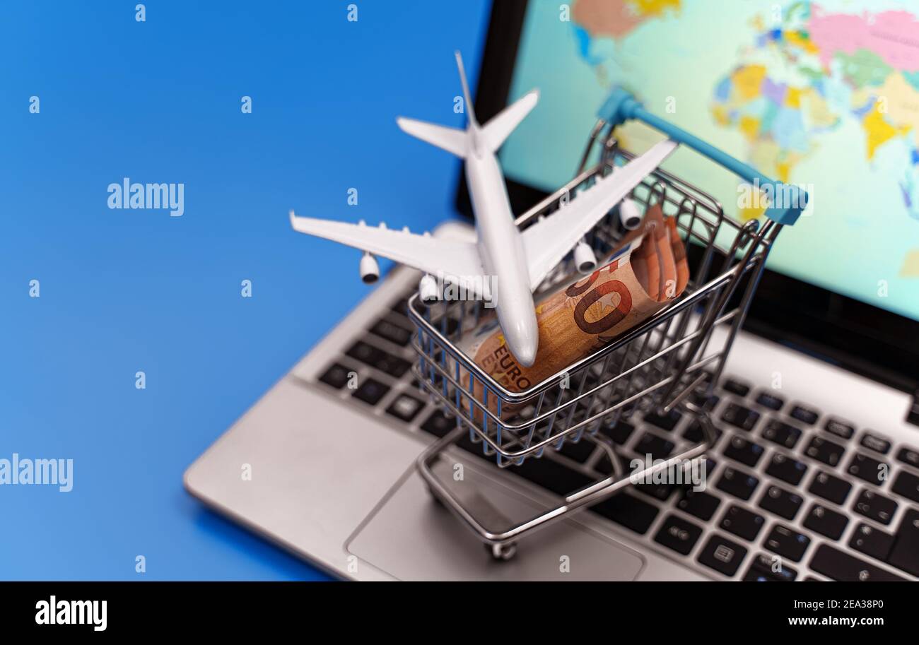 Shopping cart with plane toy. Air tickets sale concept Stock Photo - Alamy