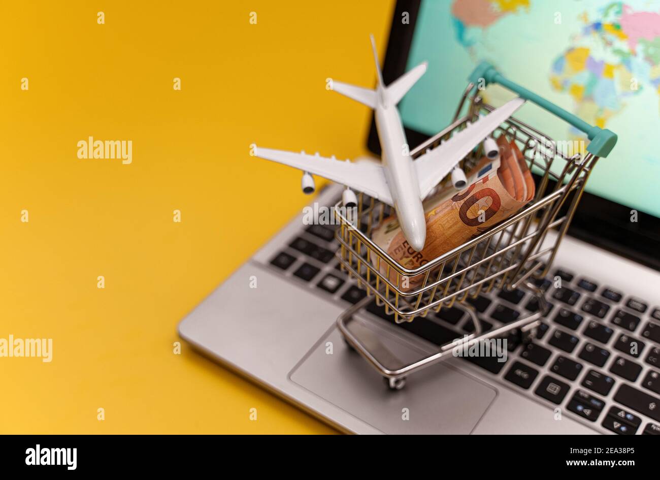 Shopping cart with plane toy. Air tickets sale concept Stock Photo - Alamy