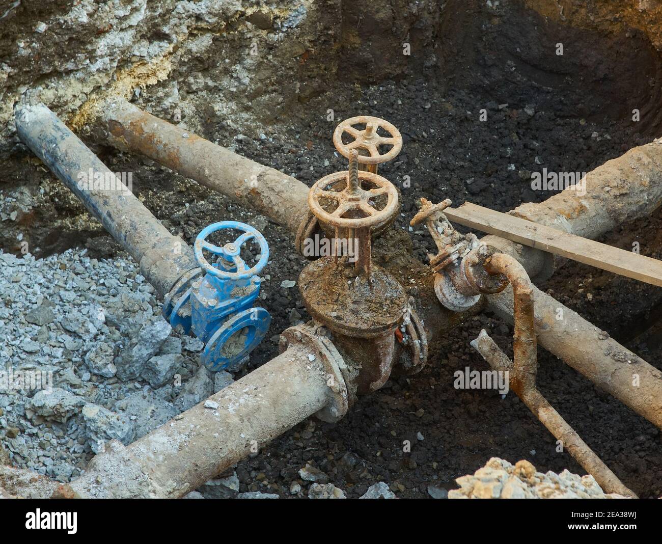 Old city water main taps, a hole dug to repair or replace water supply ...