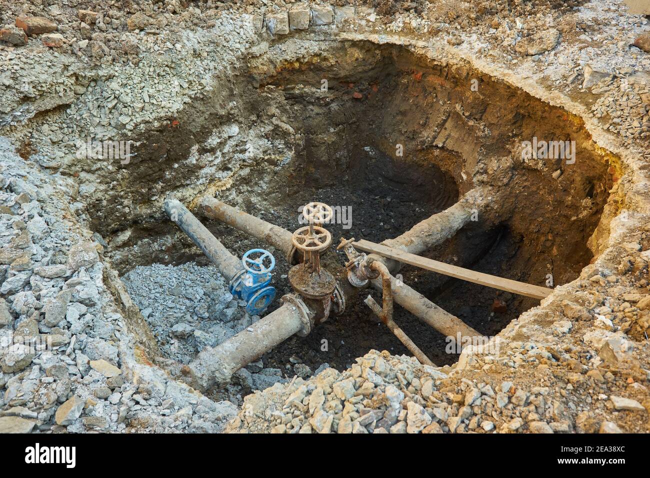 Old city water main taps, a hole dug to repair or replace water supply ...