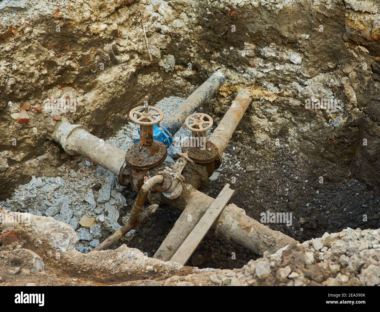 Old city water main taps, a hole dug to repair or replace water supply ...