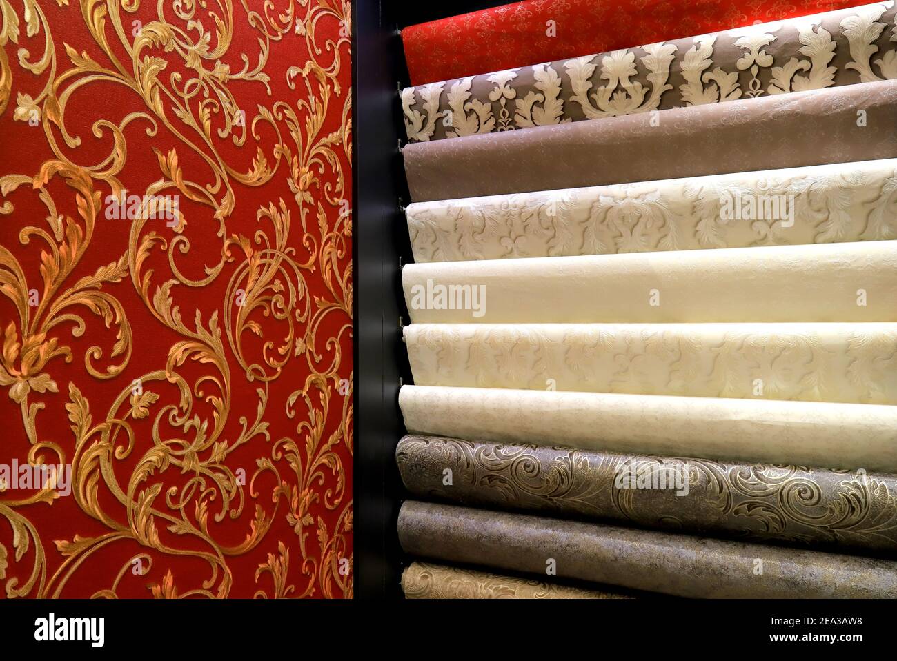 Rolls of vinyl quality wallpaper in a building supermarket, store ...