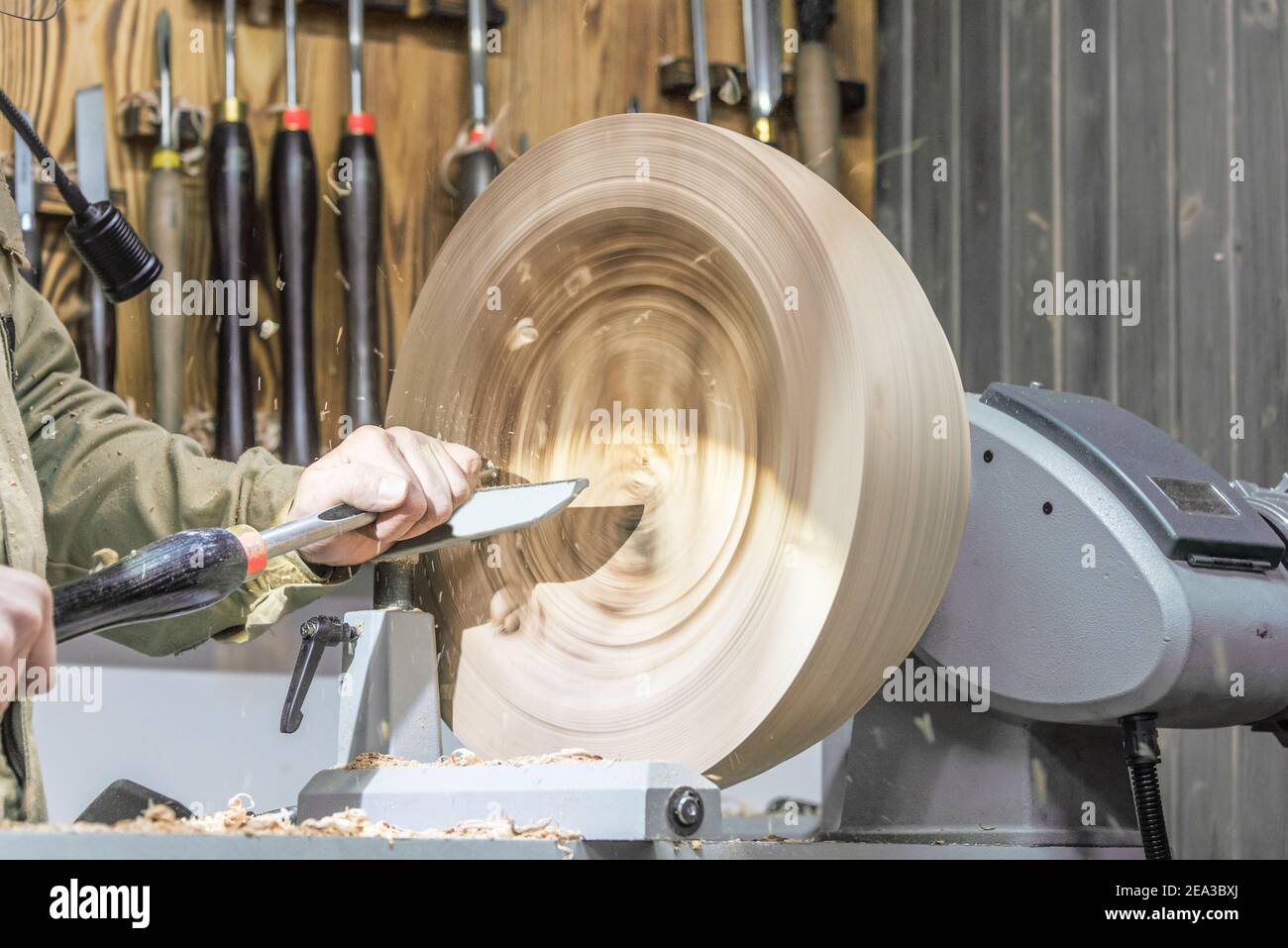Turning wooden bowls on a lathe. The close up view of spinning the ...
