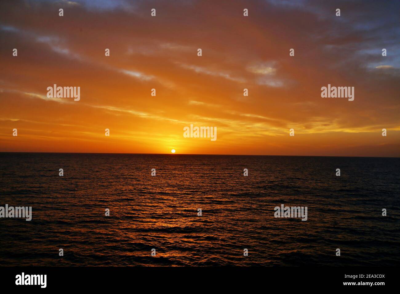 Sun rise over the ocean Stock Photo - Alamy