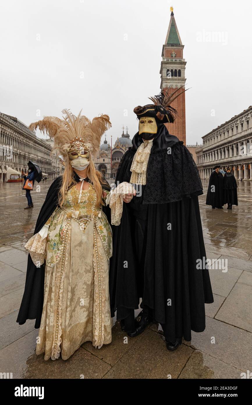 A man in a traditional bauta costume with lava mask and feathered ...