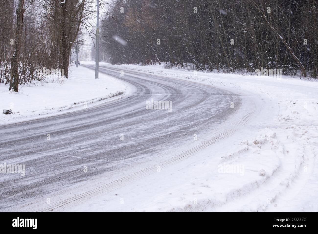 Snow and car wheel marks on the road close up Stock Photo - Alamy