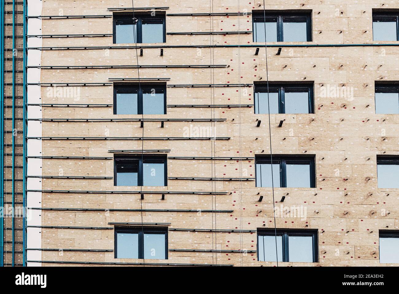 Installation of insulation on the exterior facade of a multi-storey ...