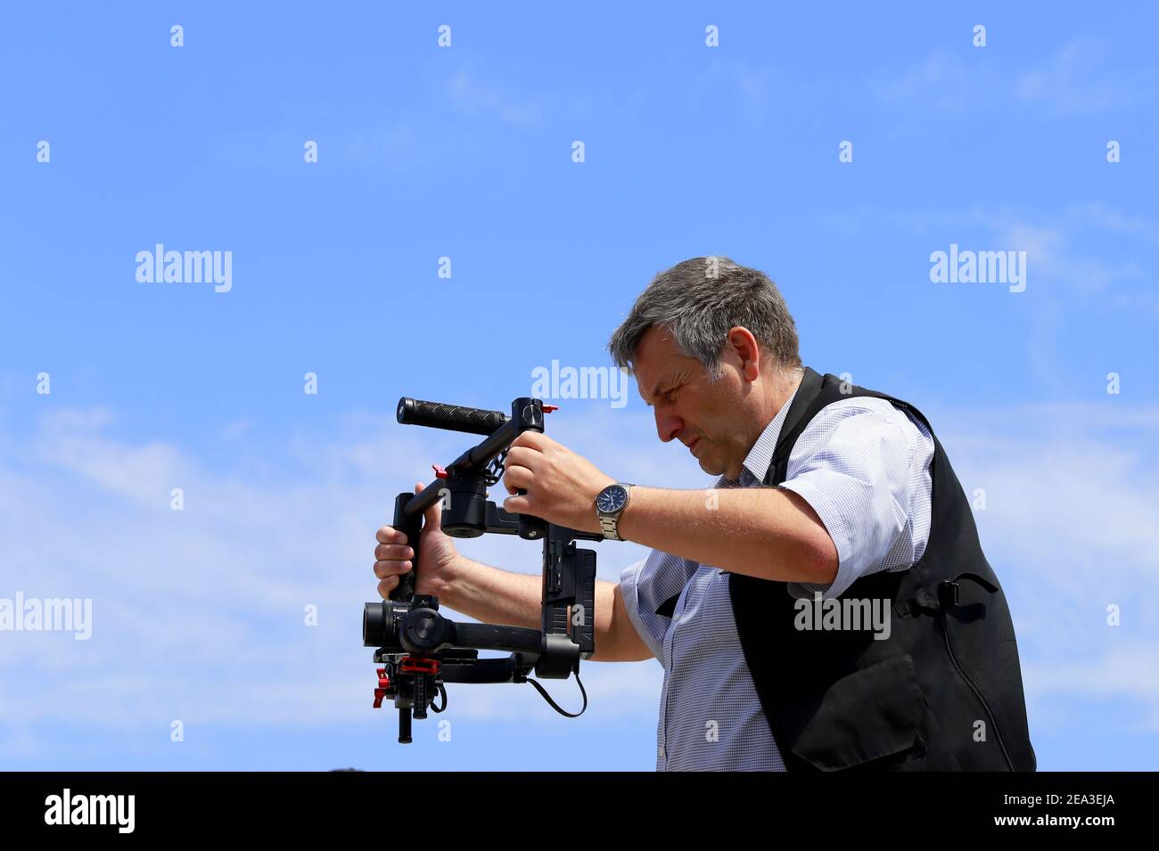 A videographer shoots video on a city street. Television journalist ...