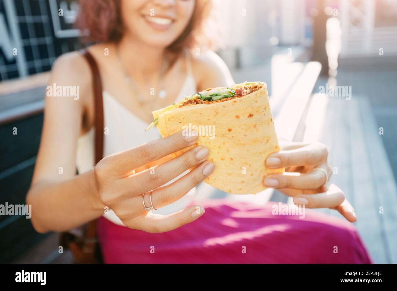 Girl woman eating a burrito hi-res stock photography and images - Alamy