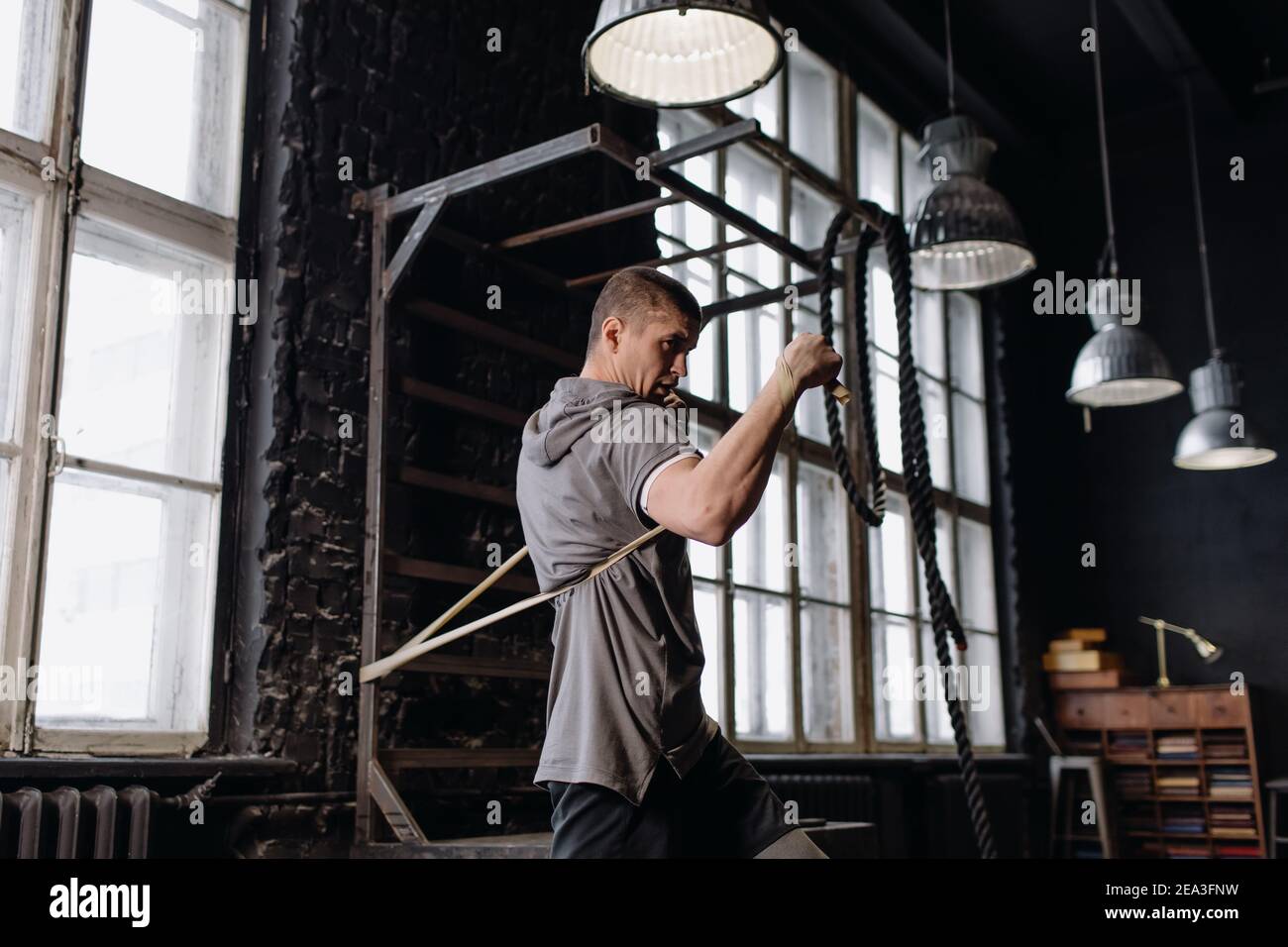 Cool man fighter in boxing bandages trains in the gym. Mixed martial ...