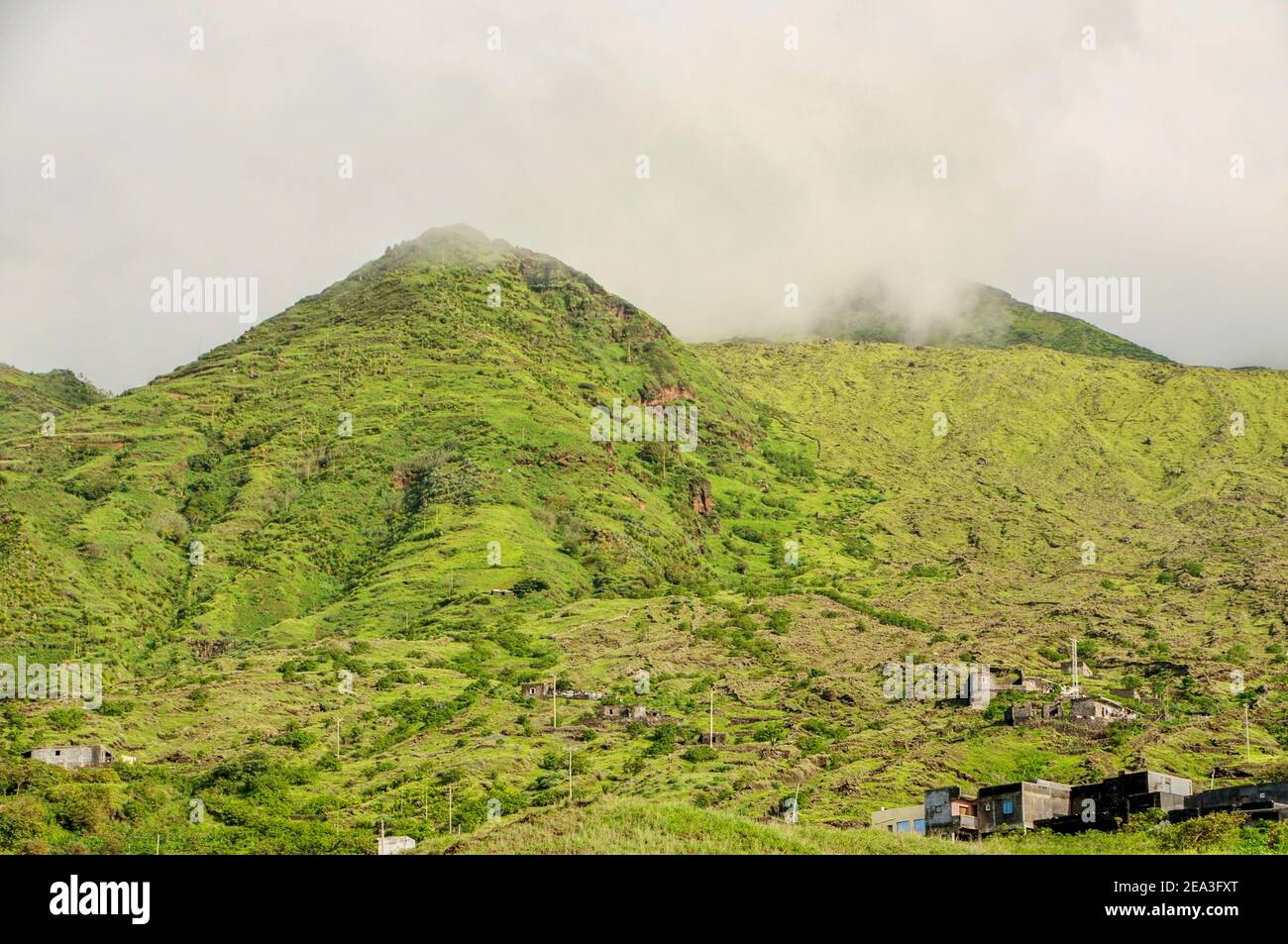The town of Sao Jorge, a volcanic landscape covered in green vegetation ...
