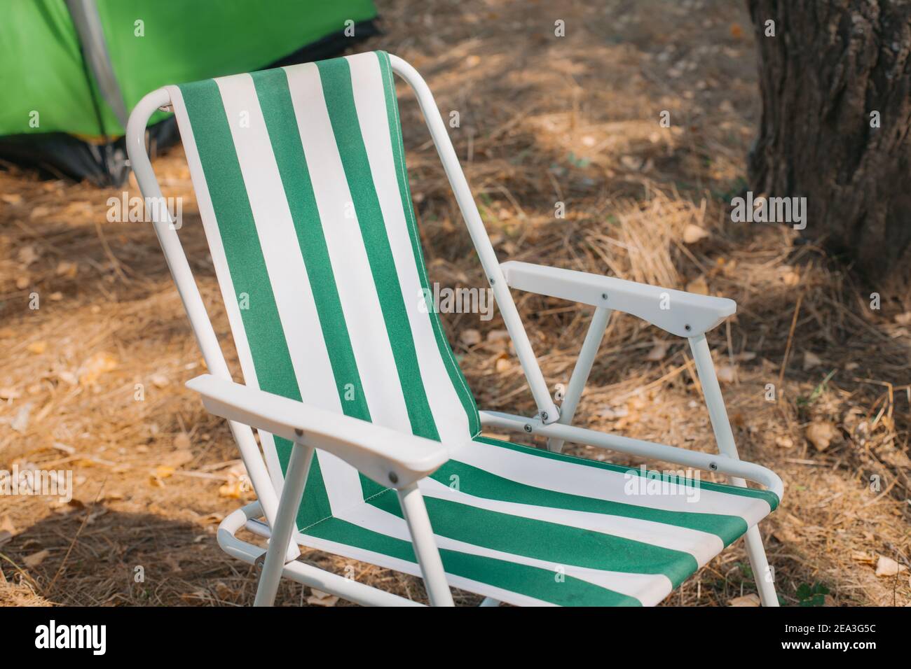 Camping chair on the background of the tent. Outdoor recreation with ...