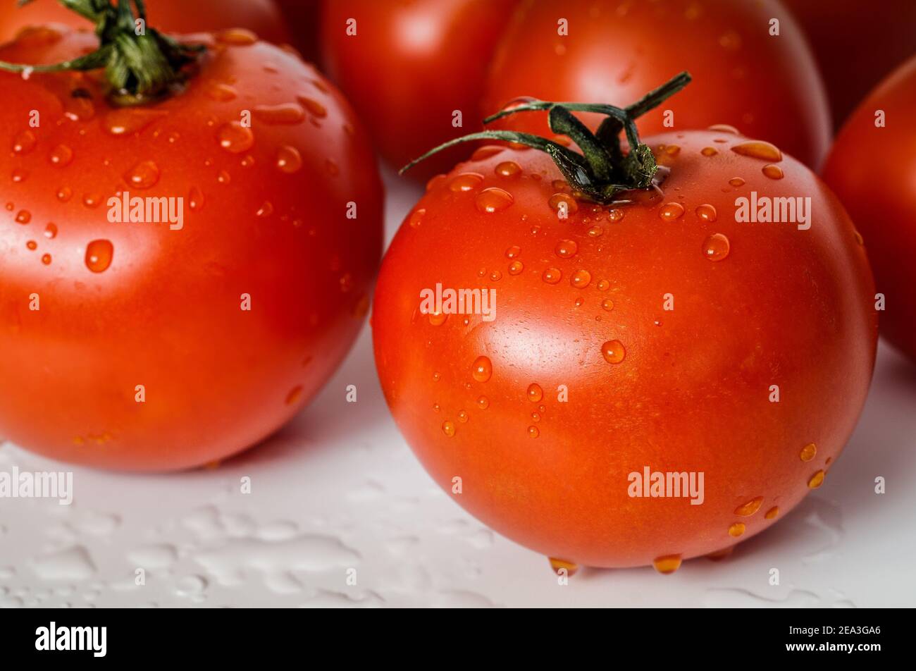 water drops on red ripe tomatoes, photographed from a short distance ...